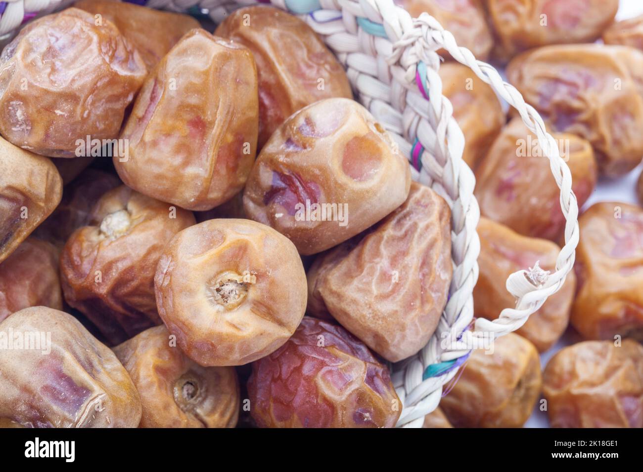 A group of stuffed sukkari dates with nuts and herbs isolated on white ...