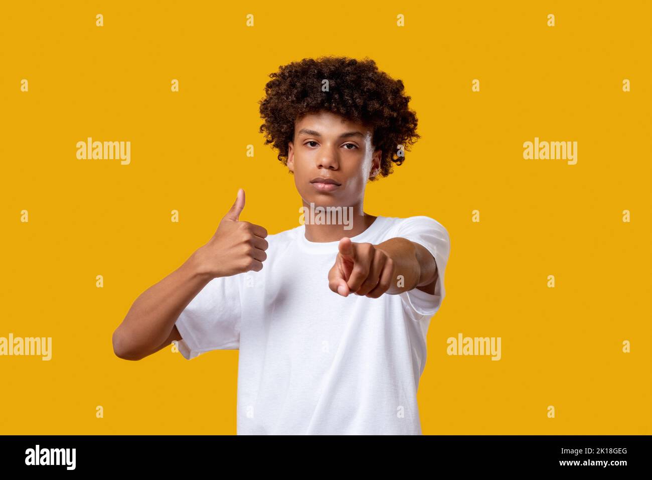 Like gesture. Well done. Black teenager boy showing thumb up pointing ...