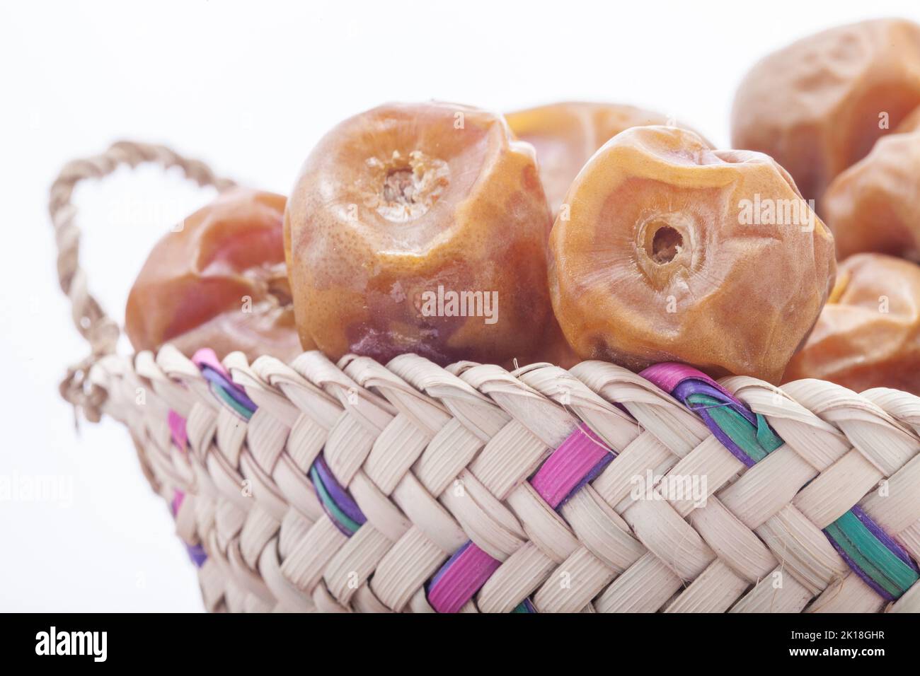 A group of stuffed sukkari dates with nuts and herbs isolated on white ...