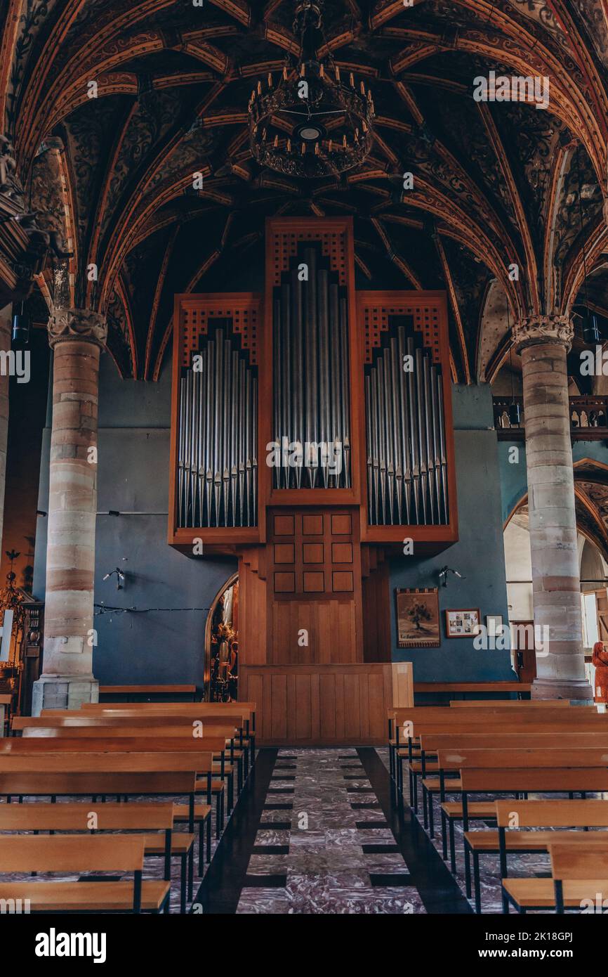 The interior of an old Eglise Saint-Pierre church in a vertical shot ...