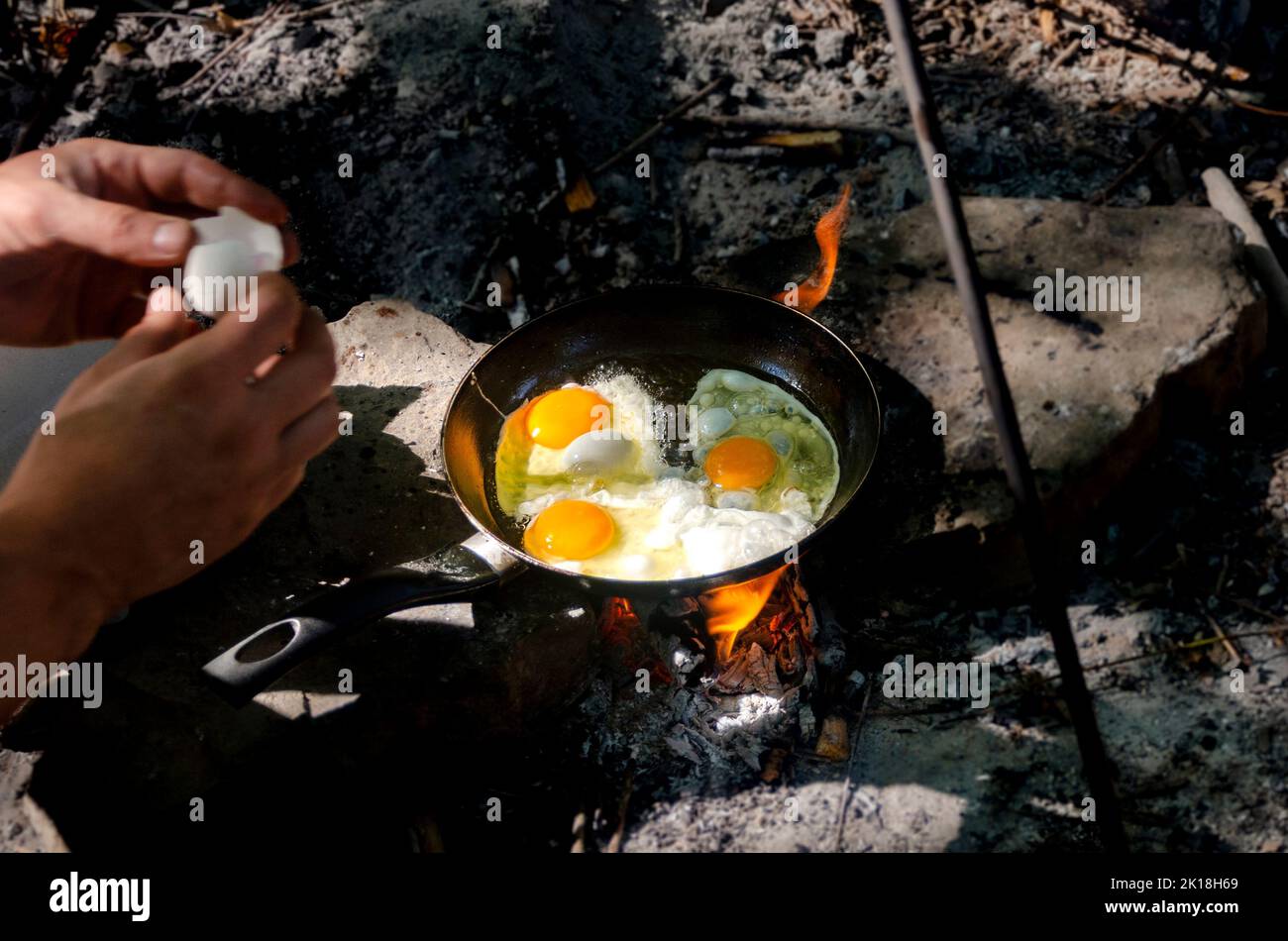 Breakfast in the woods. Breakfast on a hike. Classic egg in a frying ...