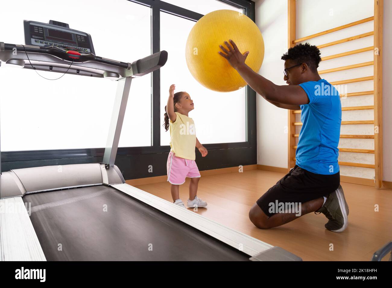 Black father and daughter exercising with fit ball Stock Photo - Alamy