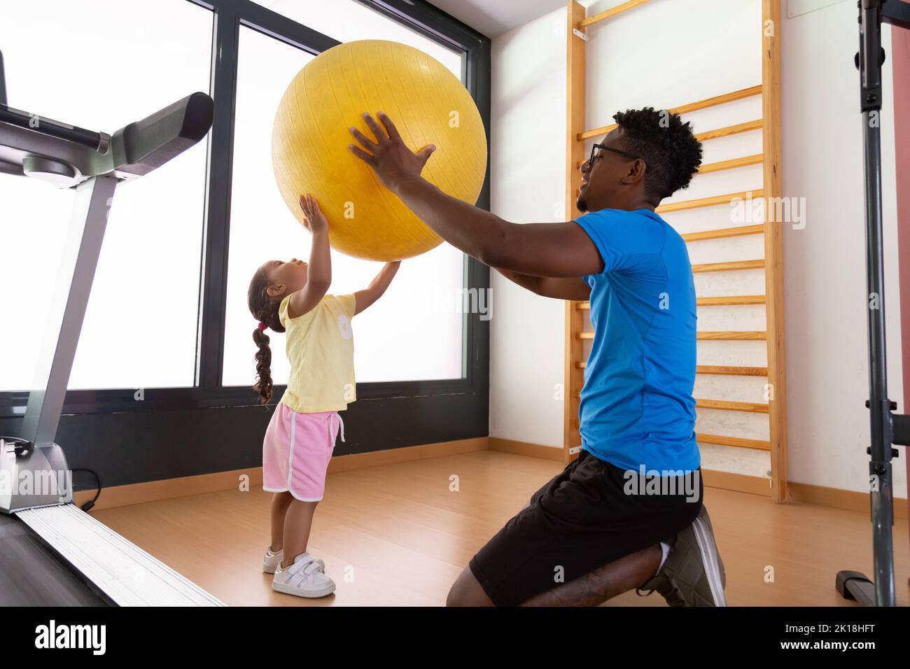 Black father and daughter exercising with fit ball Stock Photo - Alamy