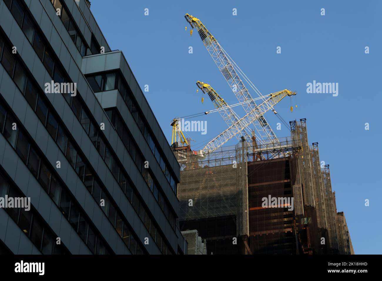 High-rise construction tower crane against the backdrop of a beautiful ...