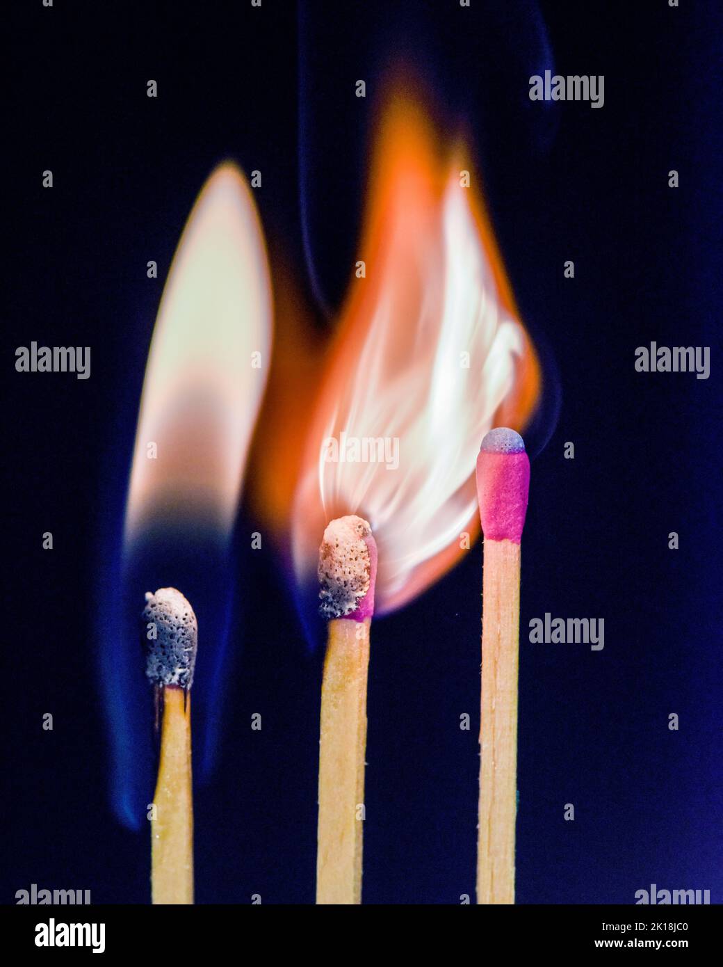 Three matches, one catching fire from the other. Concept: teamwork ...