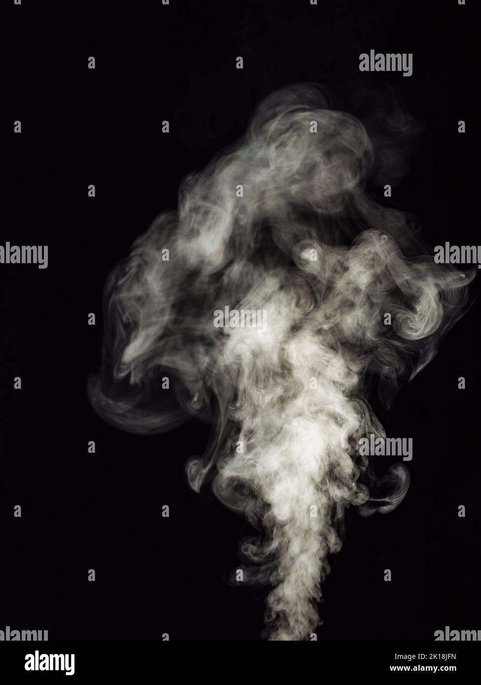 White smoke on a black background, rising in balls as an abstract ...