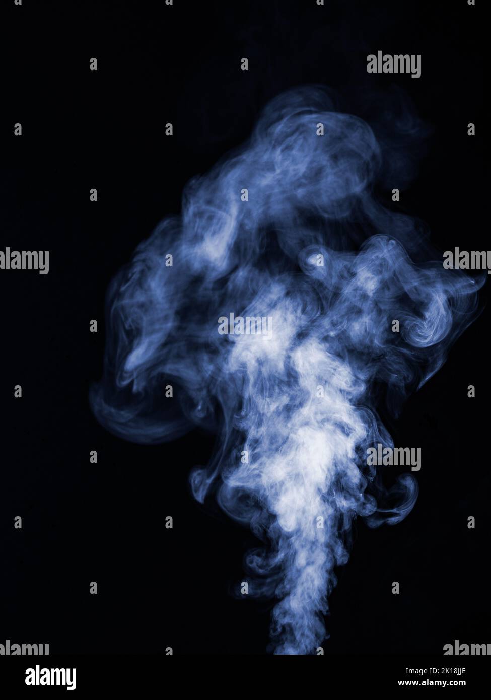 Blue smoke on a black background, rising in balls as an abstract effect ...