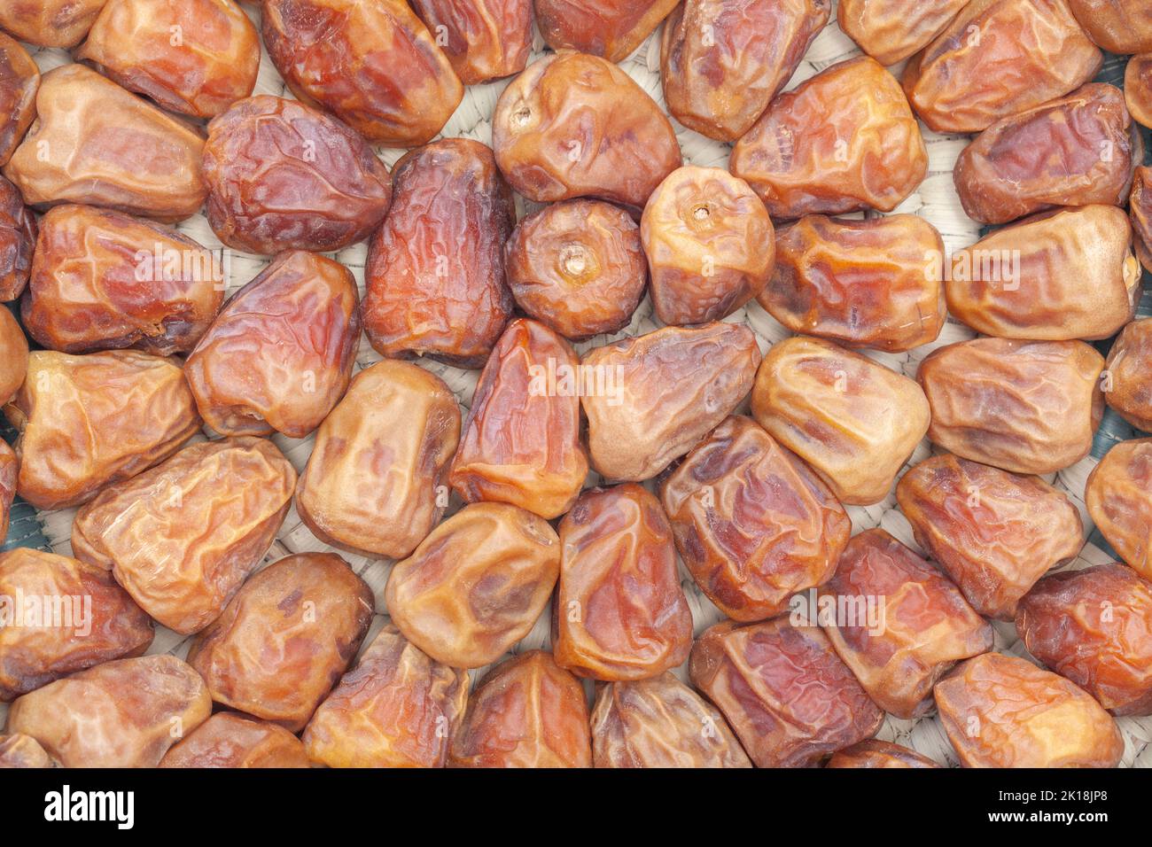 A group of stuffed sukkari dates with nuts and herbs isolated on white ...