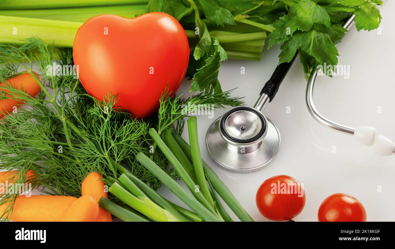 Healthy food concept. Natural vegetables with stethoscope and red heart ...