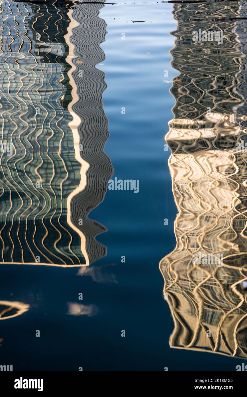 Reflections in water, Canary Wharf financial district on the Isle of ...