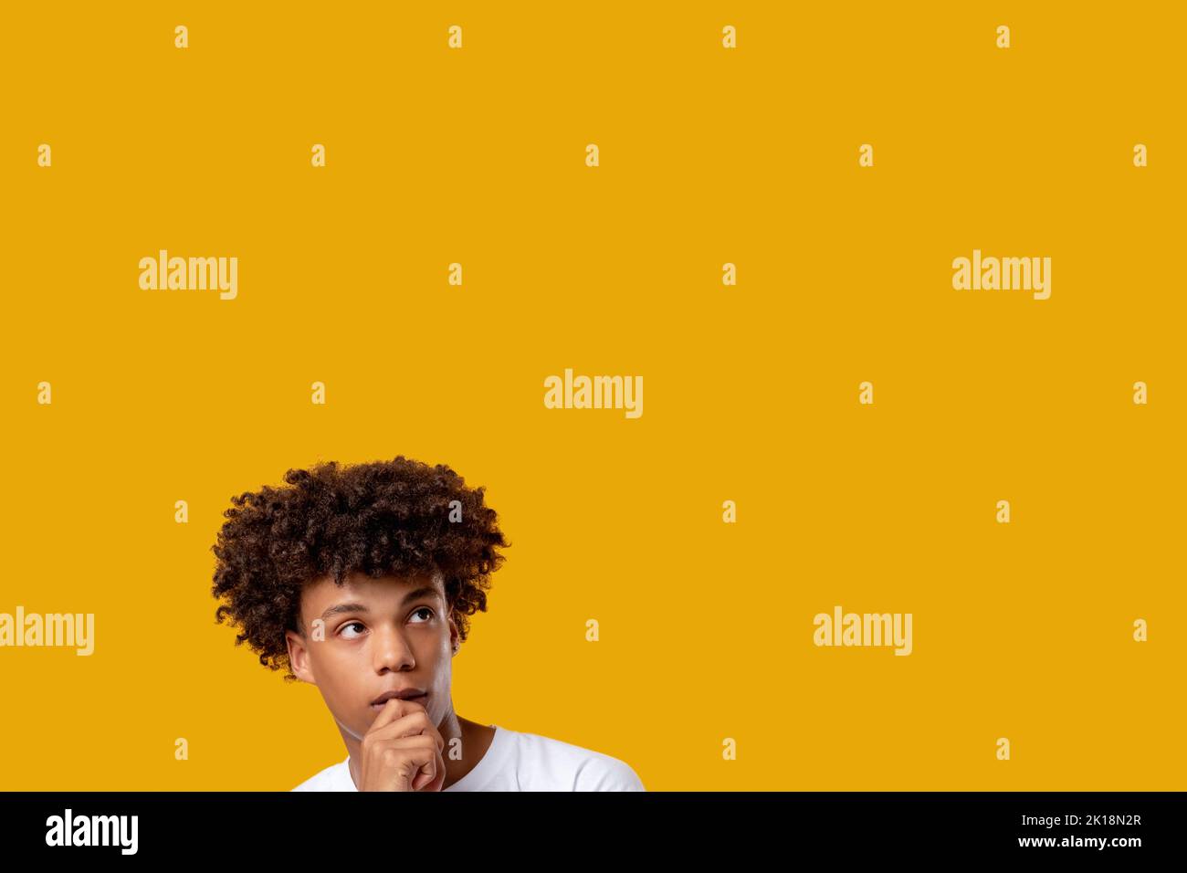 Pensive black teenager. Think idea. Young african guy in doubtful pose ...