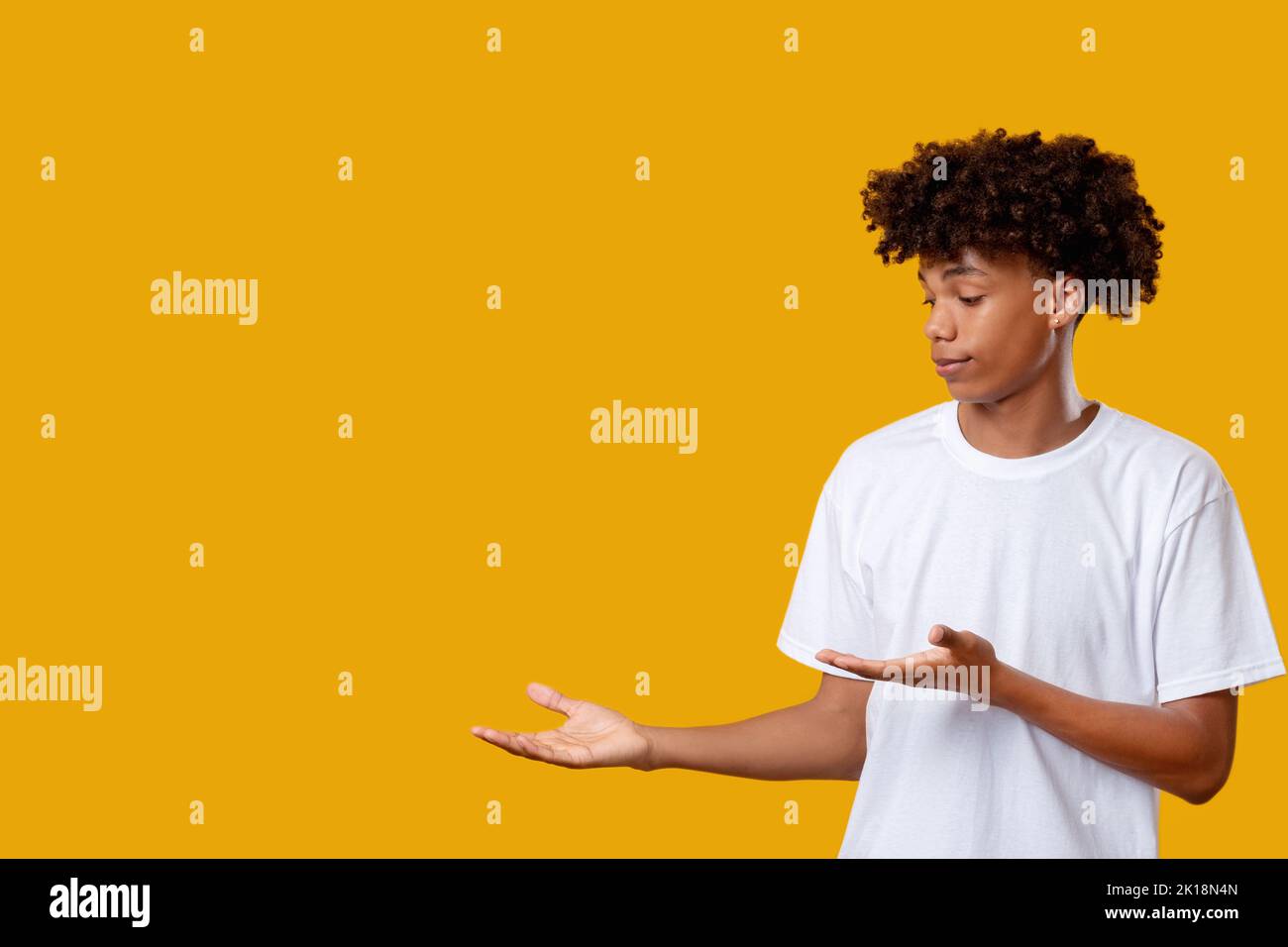 Welcome gesture. Text message. Black teenager boy showing copy space ...