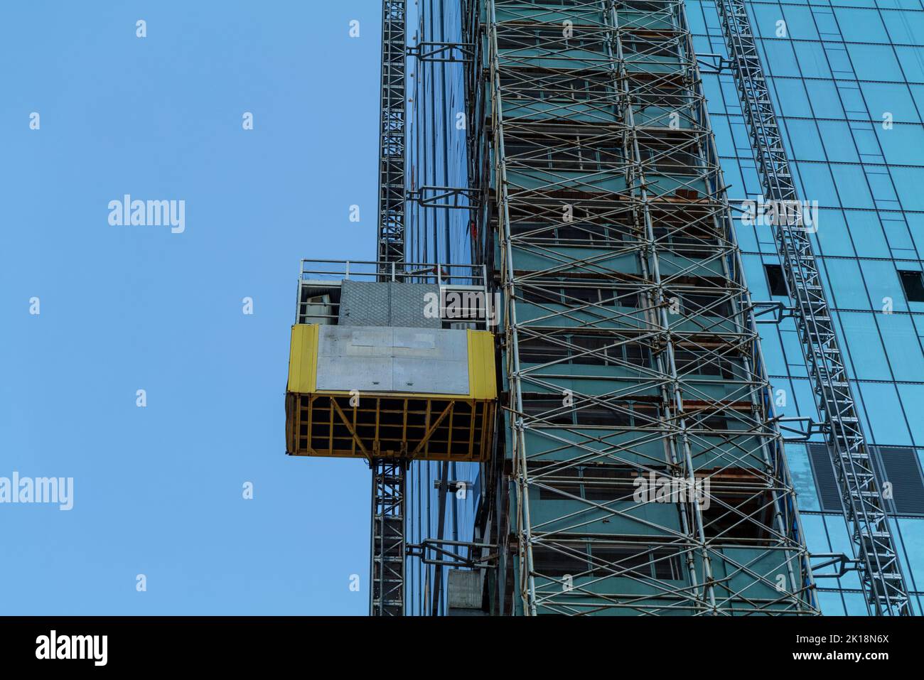 Elevator lifts for workers and materials at the construction site of a ...