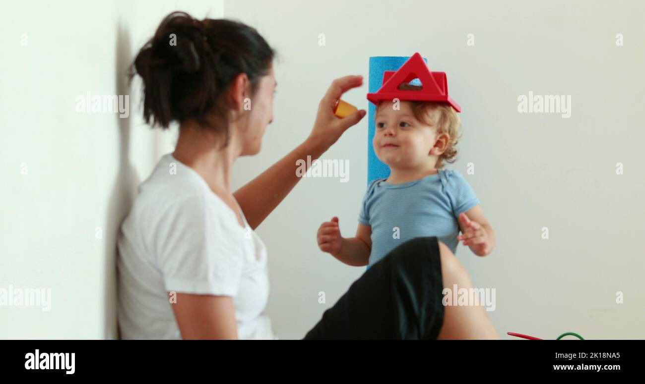 Authentic cute mother and one year old baby child interaction. Candid ...