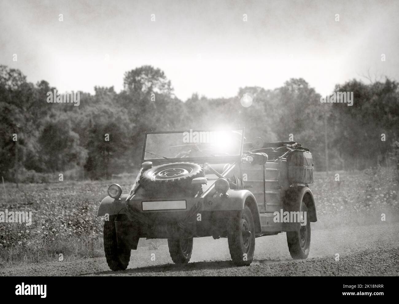 Old world war 2 era army vehicle on a country road black and white ...