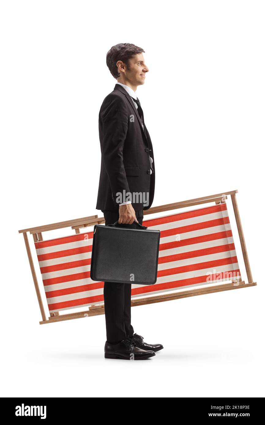 Full length profile shot of a businessman carrying a beach chair and a ...