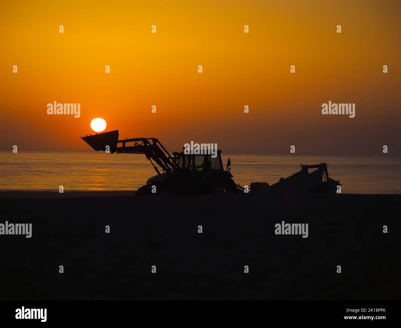 Tractor at sunset at a beach Stock Photo - Alamy