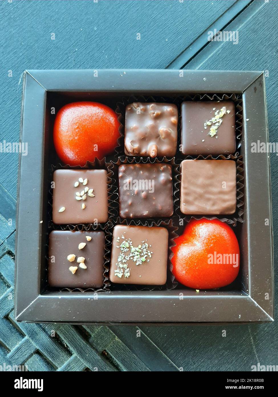Handmade chocolates in different colours in a box Stock Photo - Alamy