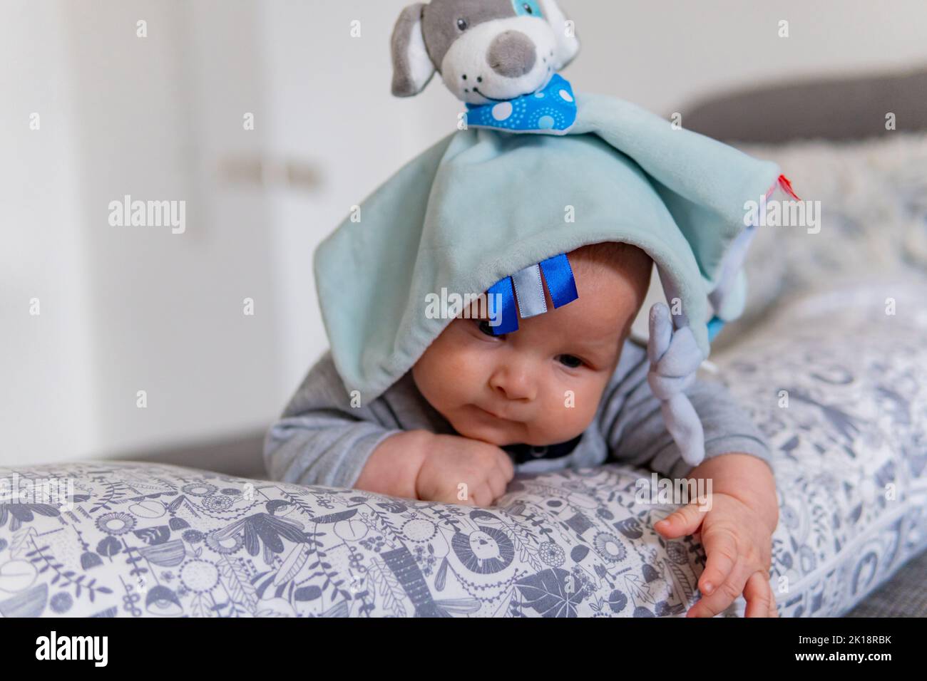 sleepy baby rests on the pillow with a toy cap on his head Stock Photo ...