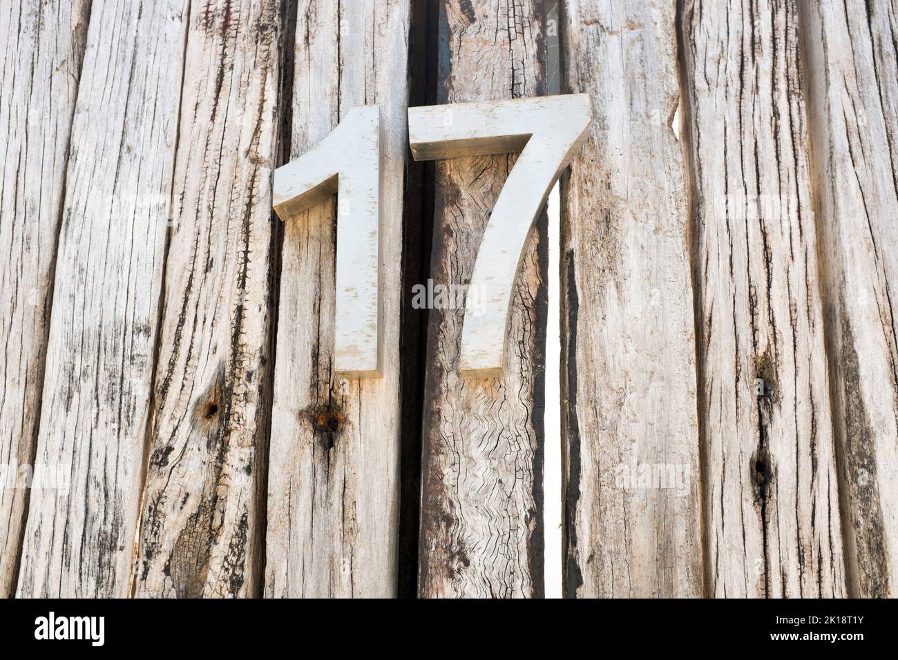 Number 17 on the grey wooden front door of a property in Santa Eulària ...