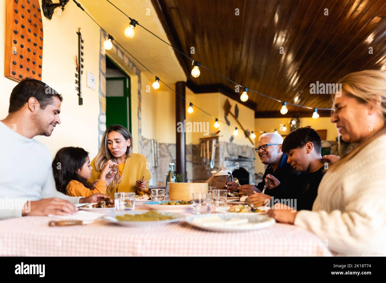 Happy Latin family having fun lunching together at home Stock Photo - Alamy