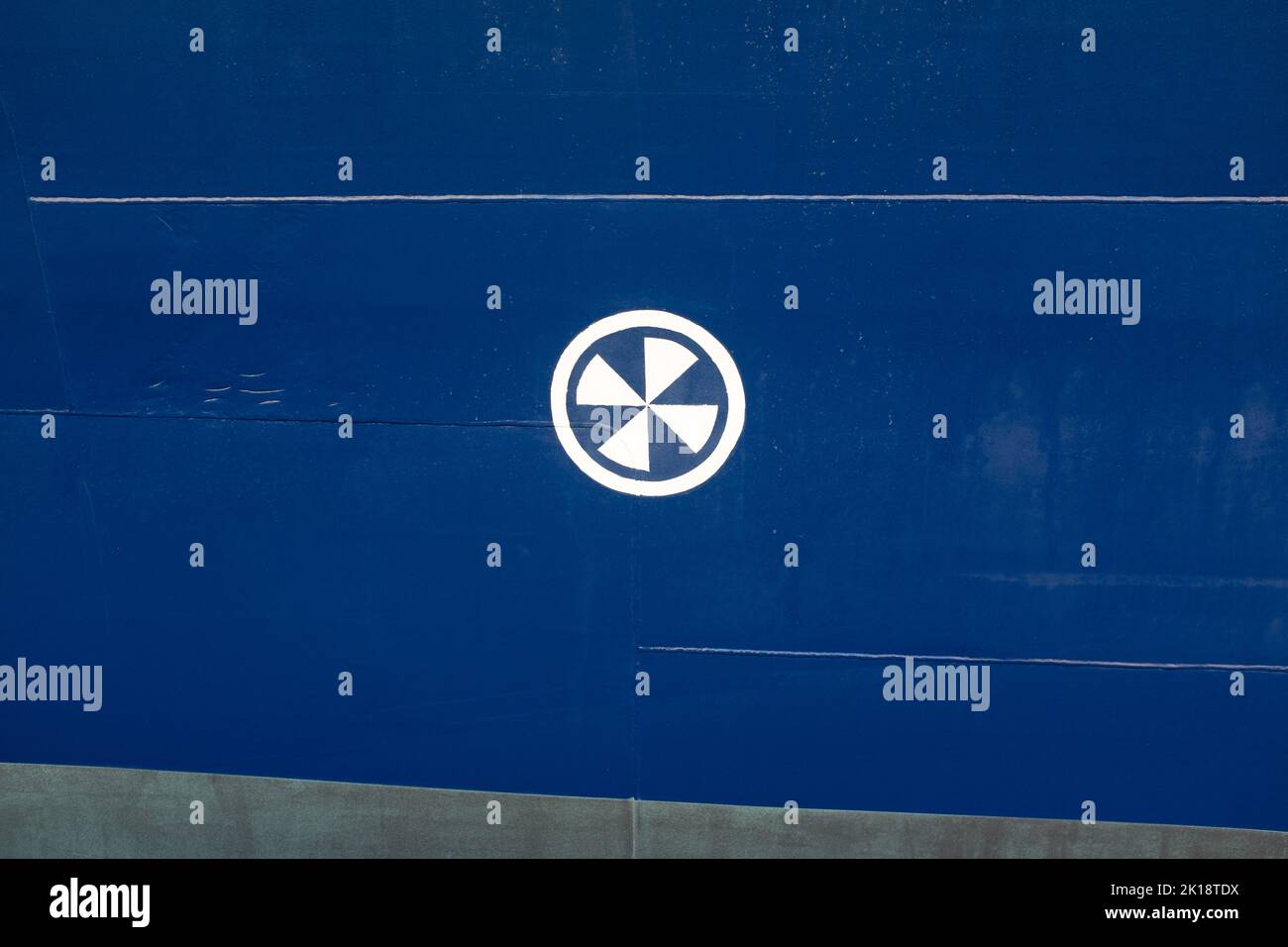 Propeller symbol on the blue painted hull of a container ship in ...