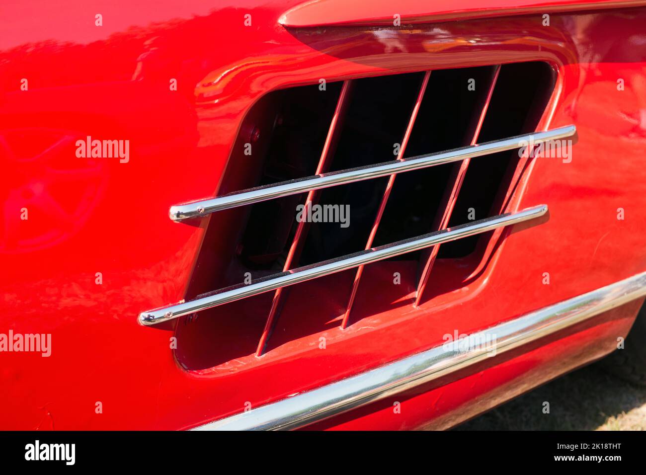 Air intake and sleek polished chrome detailing on the red bodywork of a ...