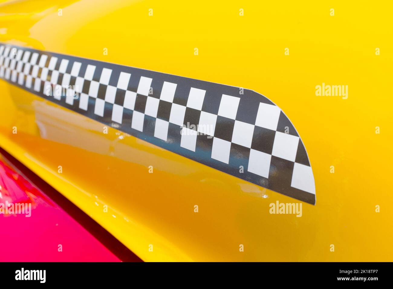 Black and white check detailing on a classic New York yellow taxi cab ...