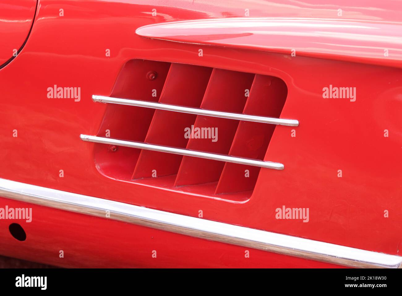 Air intake and sleek polished chrome detailing on the red bodywork of a ...