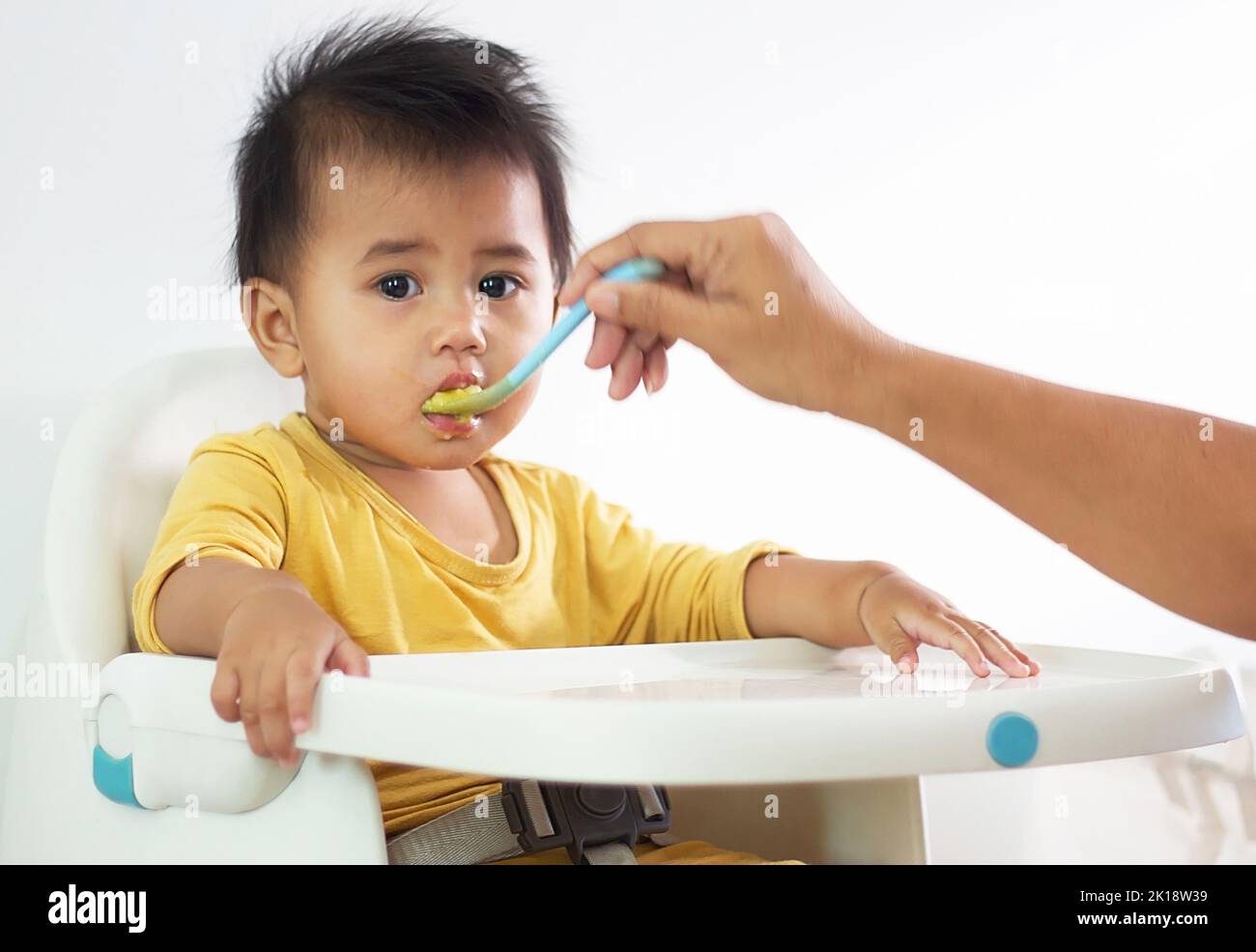Cute white girl sitting chair eating breakfast in indoor home feeding ...