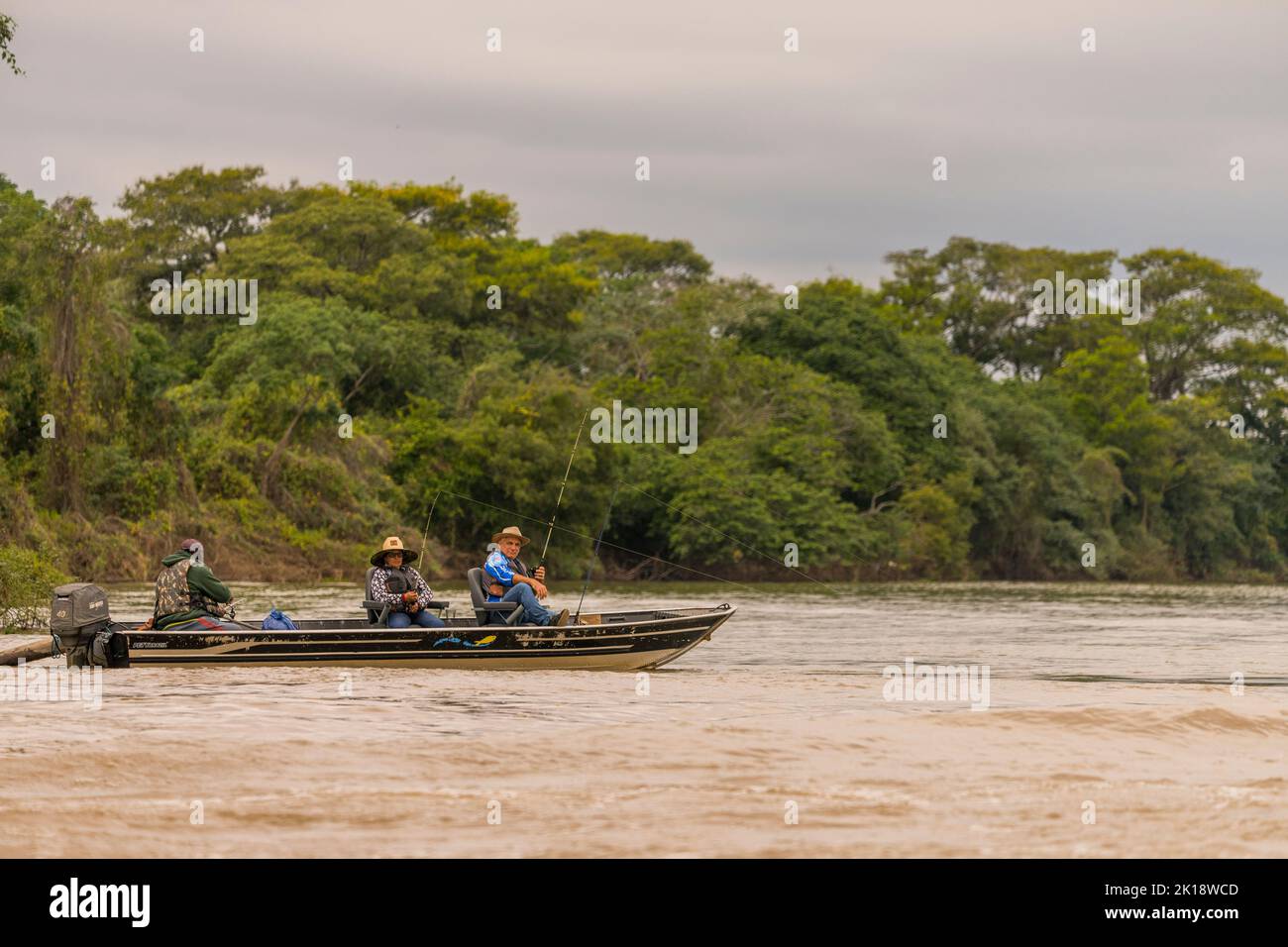Sport fisherman fishing from a boat in a tributary of the Cuiaba River ...