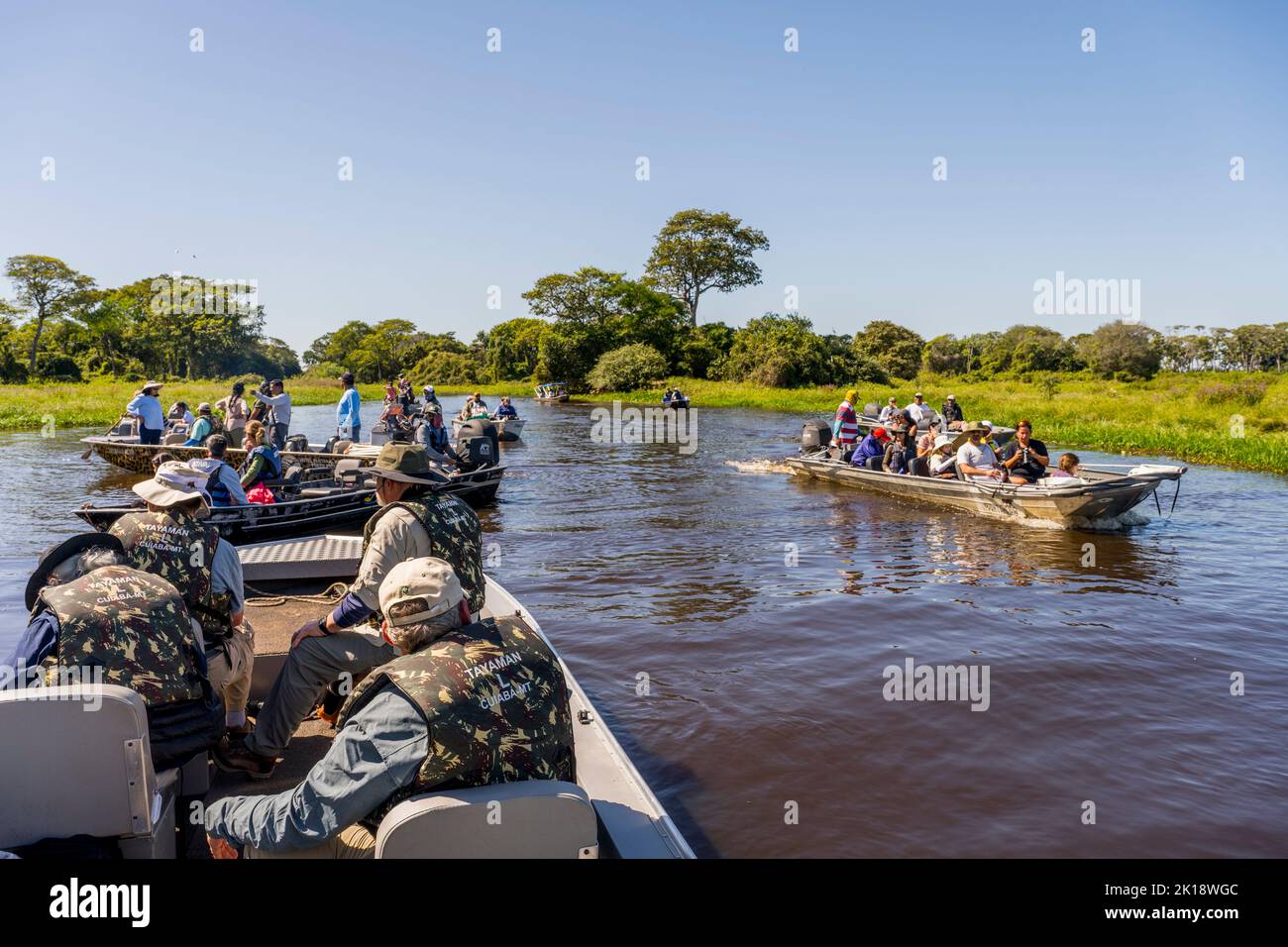 Tourists in boat on excursion to watch the wildlife in one of the ...
