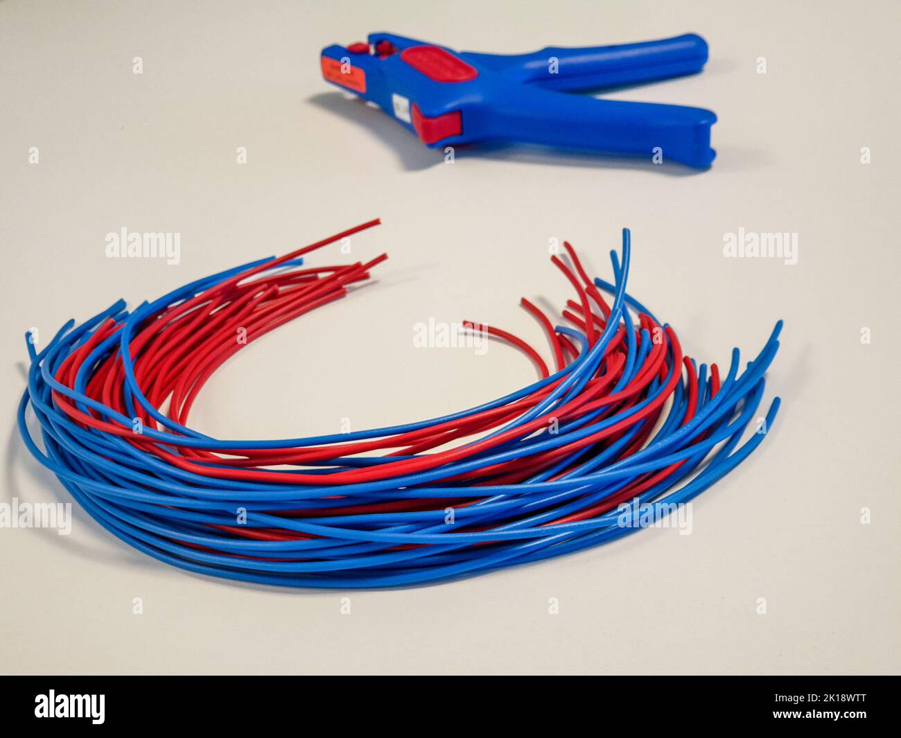 Red and blue cables and a cable cutter on white background Stock Photo ...