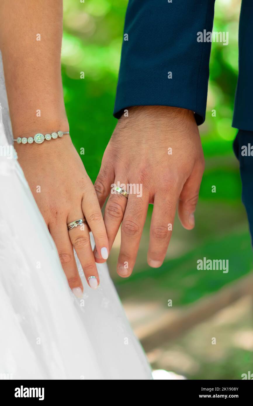 Bride and groom with wedding rings, outdoor Stock Photo - Alamy