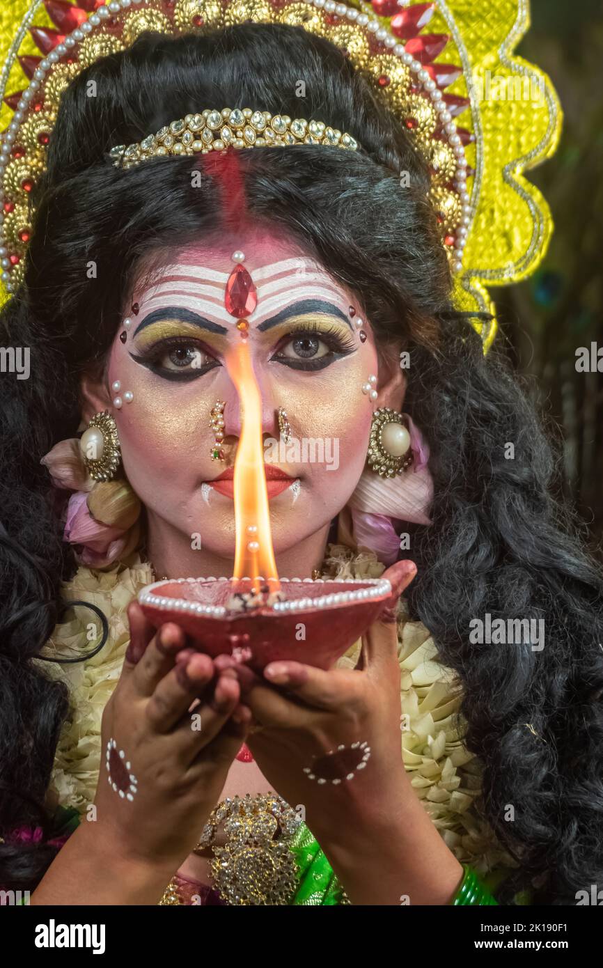 Concept Agomoni shoot with black haired Indian brunette woman face with ...