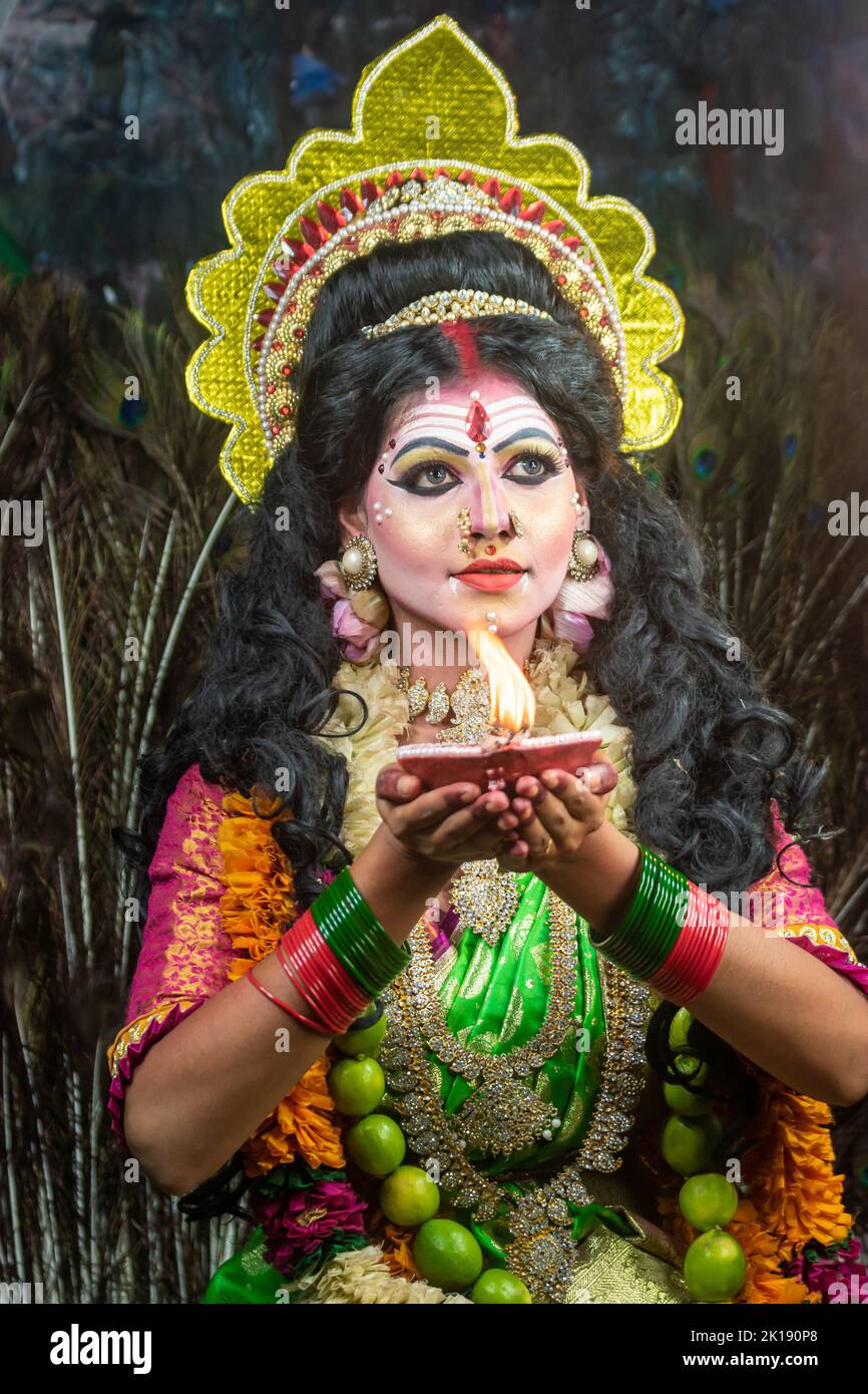 Concept Agomoni shoot with black haired Indian brunette woman face with ...