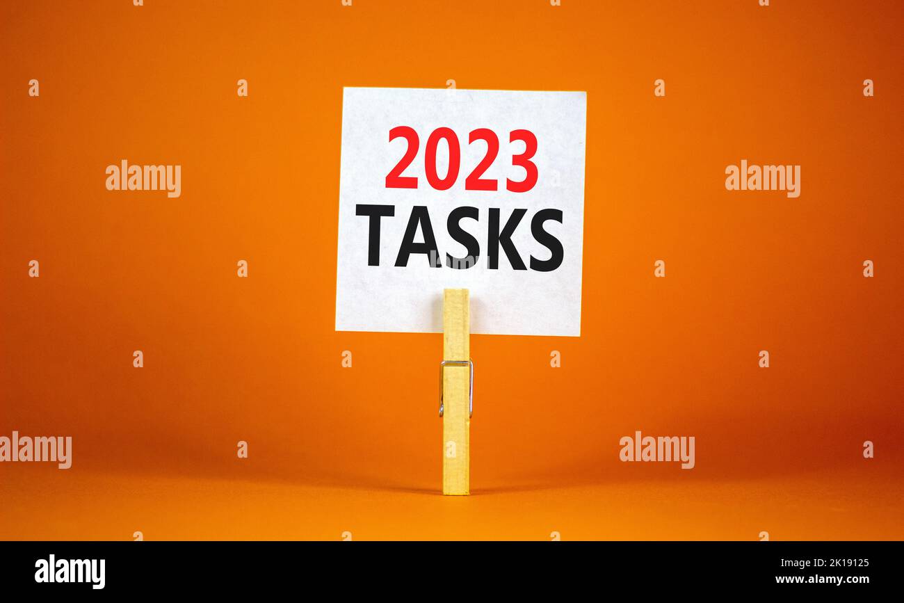 2023 Tasks symbol. White paper with words 2023 Tasks, clip on wooden ...