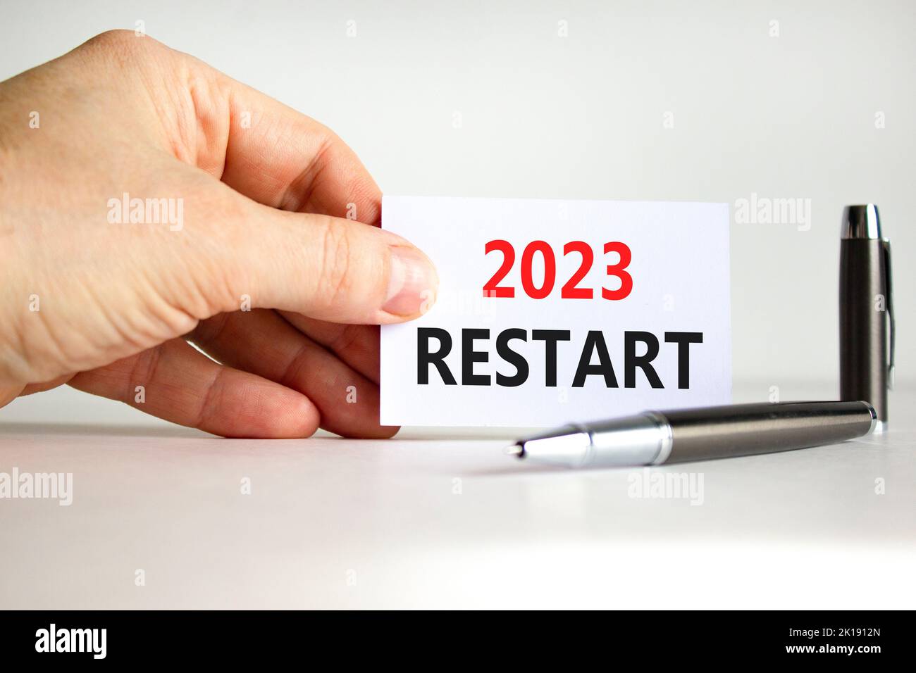 2023 Restart symbol. White paper with words 2023 Restart. Businessman ...
