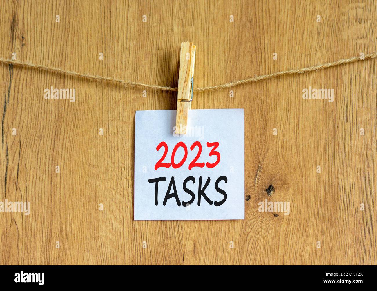 2023 Tasks symbol. White paper with words 2023 Tasks, clip on wooden ...