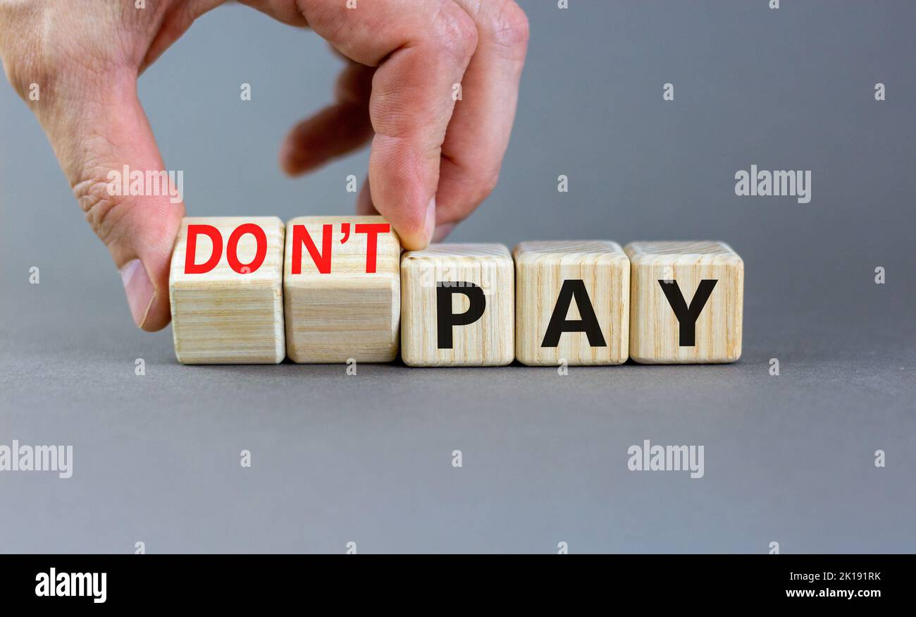 Do not pay symbol. Concept words do not pay on cubes. Businessman hand ...