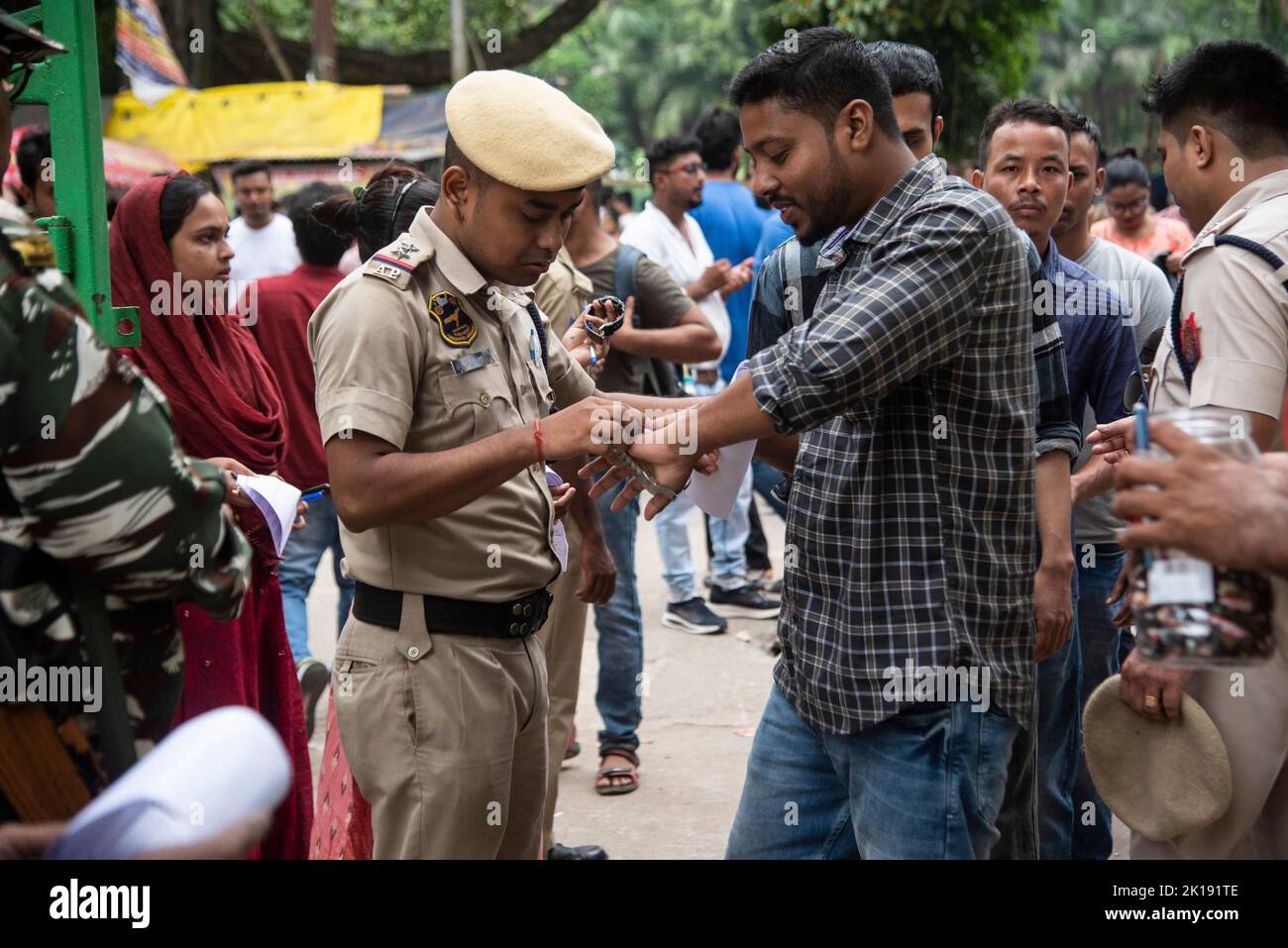 GUWAHATI, INDIA - AUGUST 28: A police person checks wrist watch of an ...