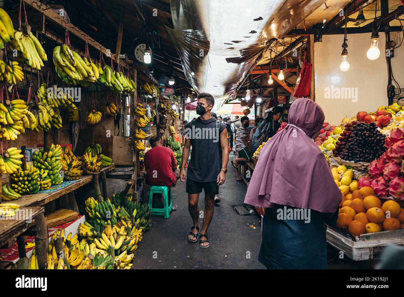 young tourist walking in a Glodok Chinatown street alley in jakarta ...