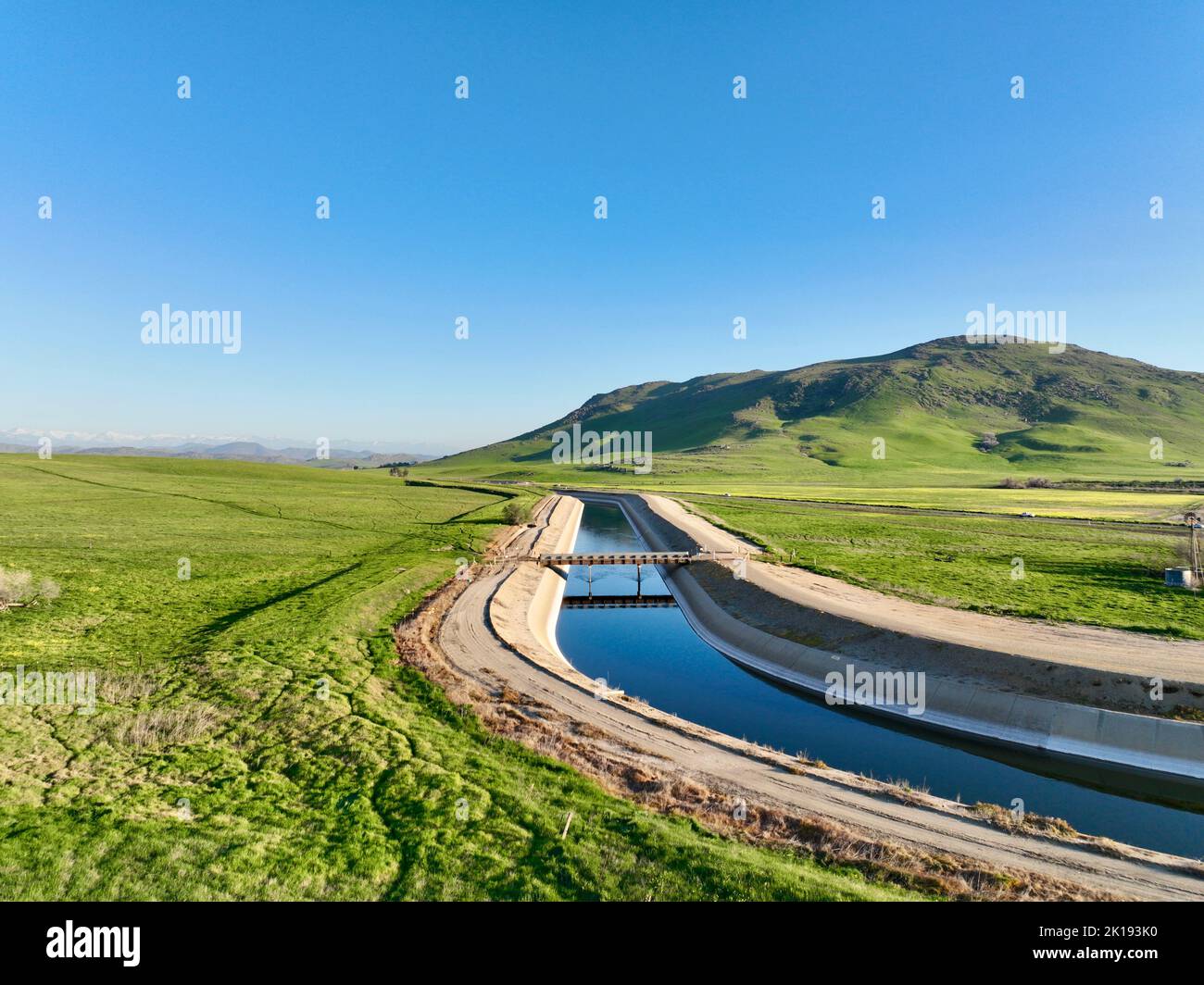 A curve canal in the middle of the field Stock Photo - Alamy