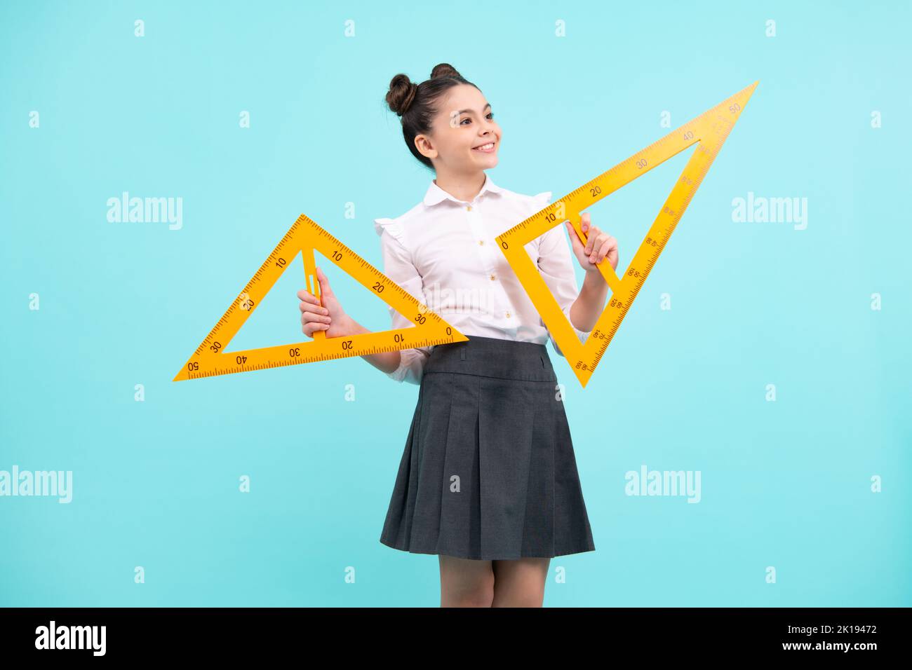 Teenager child school girl holding measure for geometry lesson ...