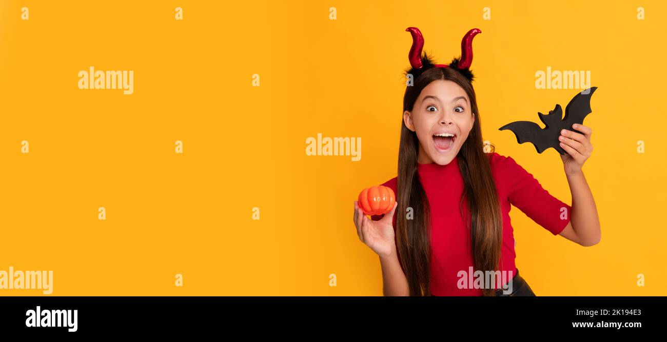 celebrate autumn party holiday. childhood fun. amazed evil child in imp ...