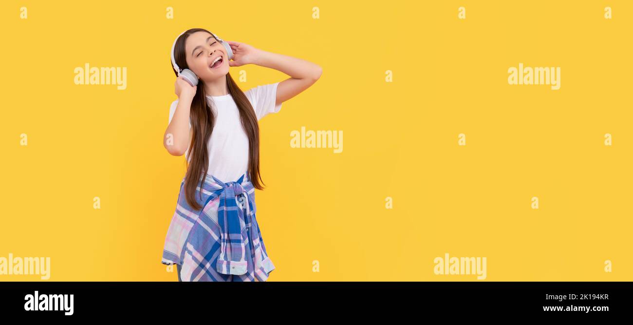 Happy kid in headphones enjoy singing song yellow background. Child ...