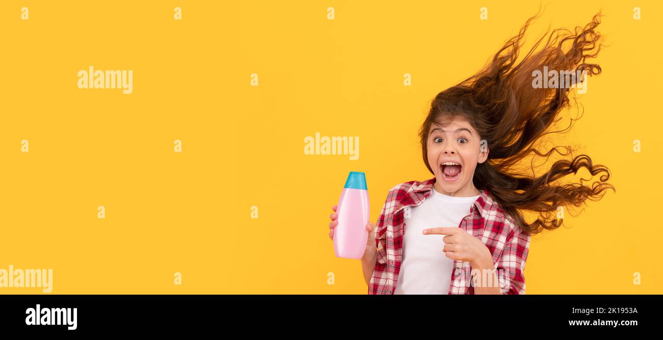 happy teen girl with long curly hair hold shampoo bottle, keratin ...