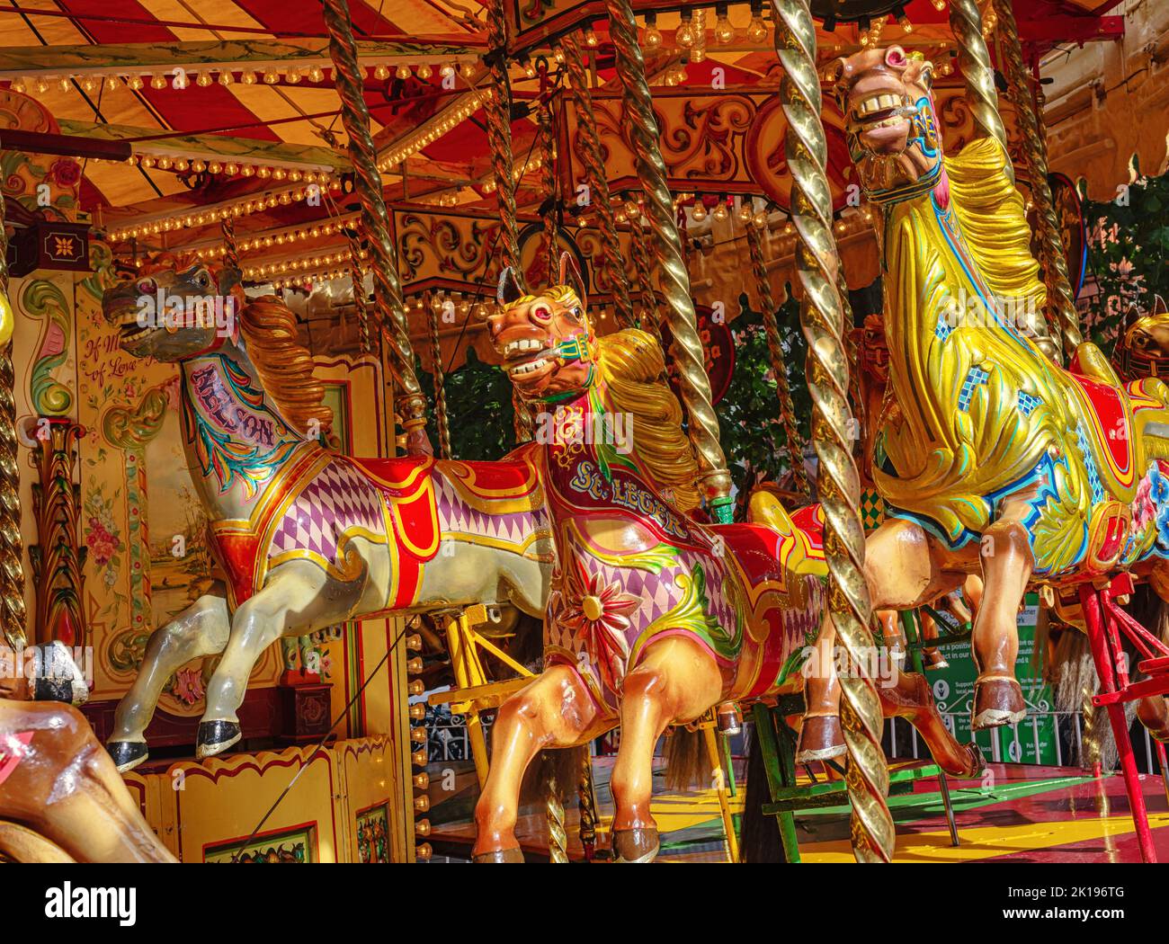 A traditional fairground ride with colourful horses set in a carousel ...
