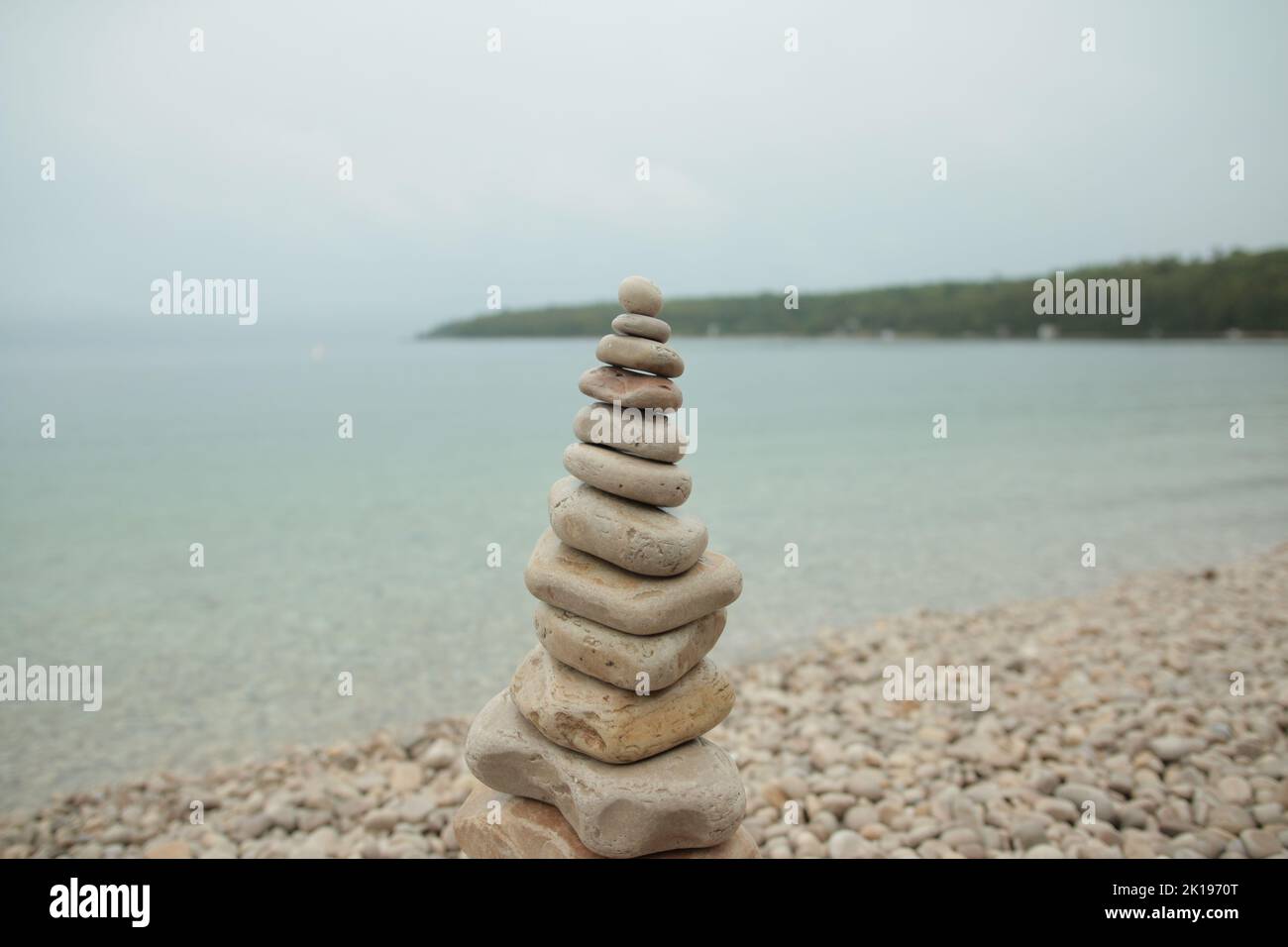Cairn rocks on a pebble beach near water Stock Photo - Alamy
