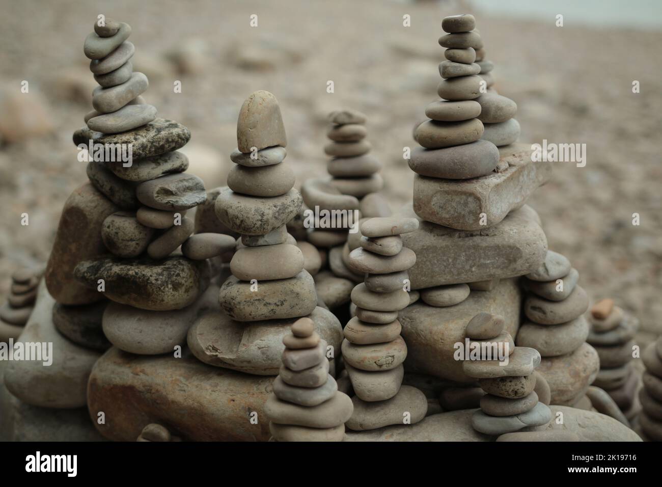 Cairn rocks on a pebble beach near water Stock Photo - Alamy